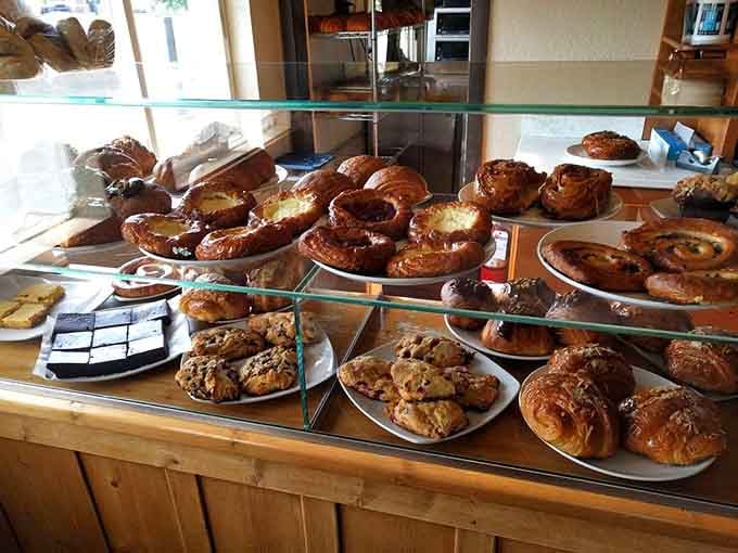 That pastry case is basically a glass monument to carbs done right, and we're here for it.