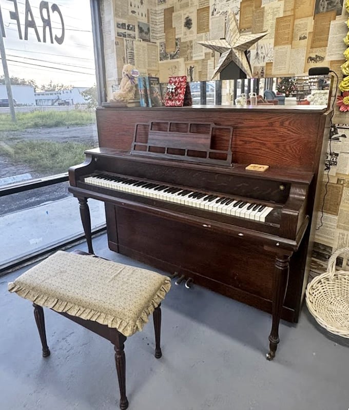An actual piano sits ready for someone to tickle the ivories between chapters of their afternoon reading session.