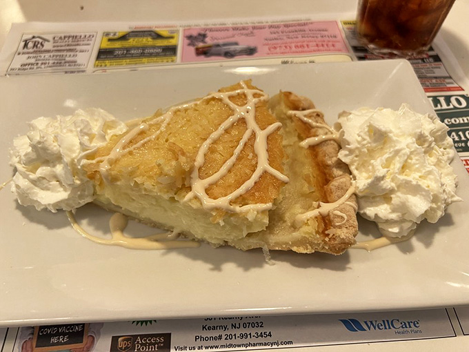 Coconut custard pie topped with whipped cream and toasted coconut, because dessert should always be dramatic.