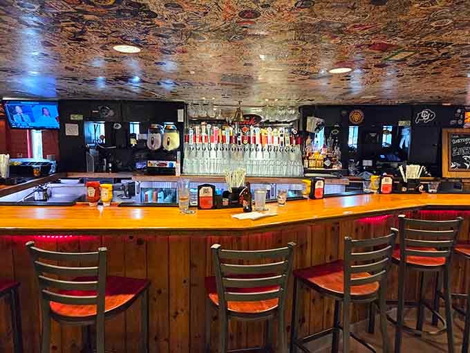 The bar features an impressive tap selection beneath that famous dollar-bill-covered ceiling that's been growing for decades.