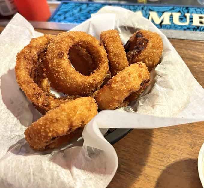 Onion rings arrive golden and crispy, the perfect supporting cast to your main event burger performance.