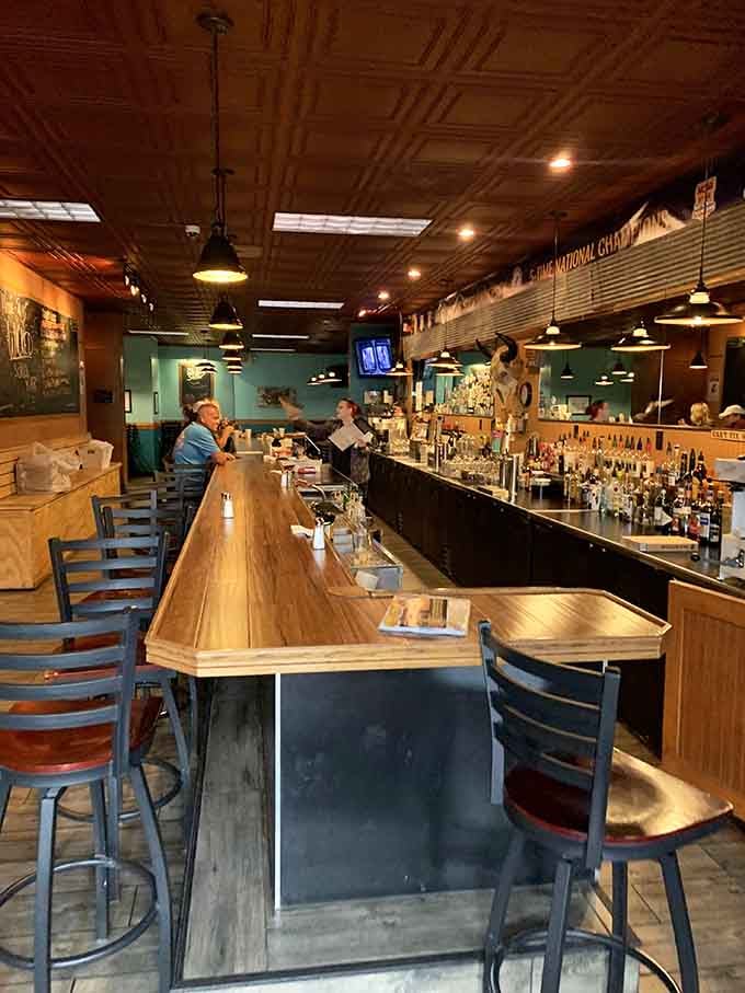 The long bar stretches invitingly, offering prime seating for solo diners or couples seeking burger enlightenment together.