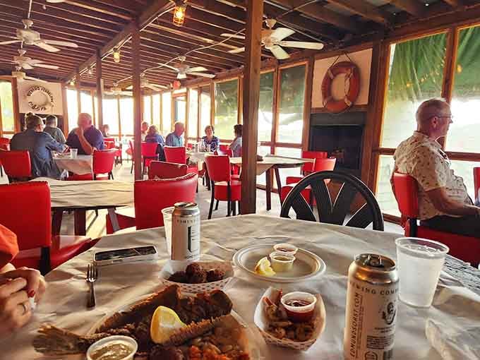 Diners enjoying their meals with creek views, proving that the best restaurants don't need fancy linens or pretentious attitudes.