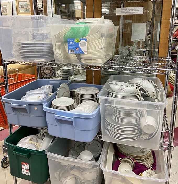 Organized chaos of dishware awaits new homes, from everyday plates to the fancy china you'll use exactly twice a year.