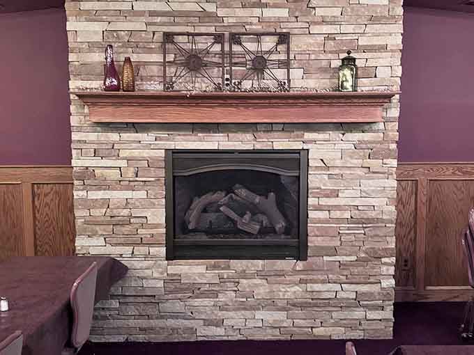 The stone fireplace adds warmth and ambiance, making every meal feel like a special occasion worth celebrating properly.