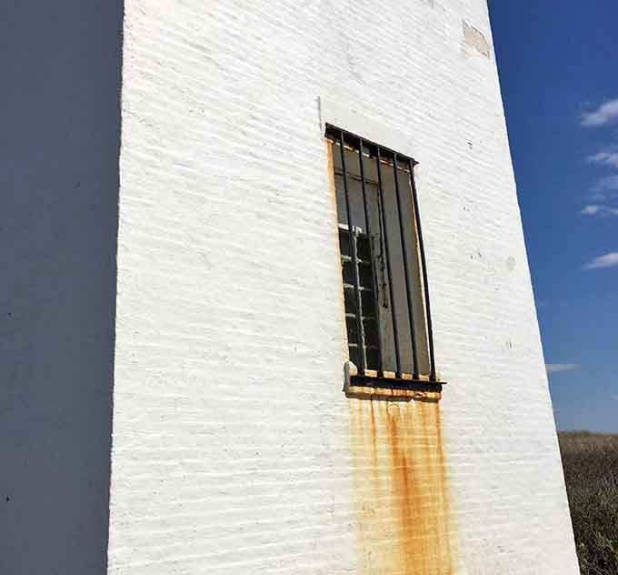 Those rust stains tell stories of salt air and countless storms that this lighthouse has faithfully endured.