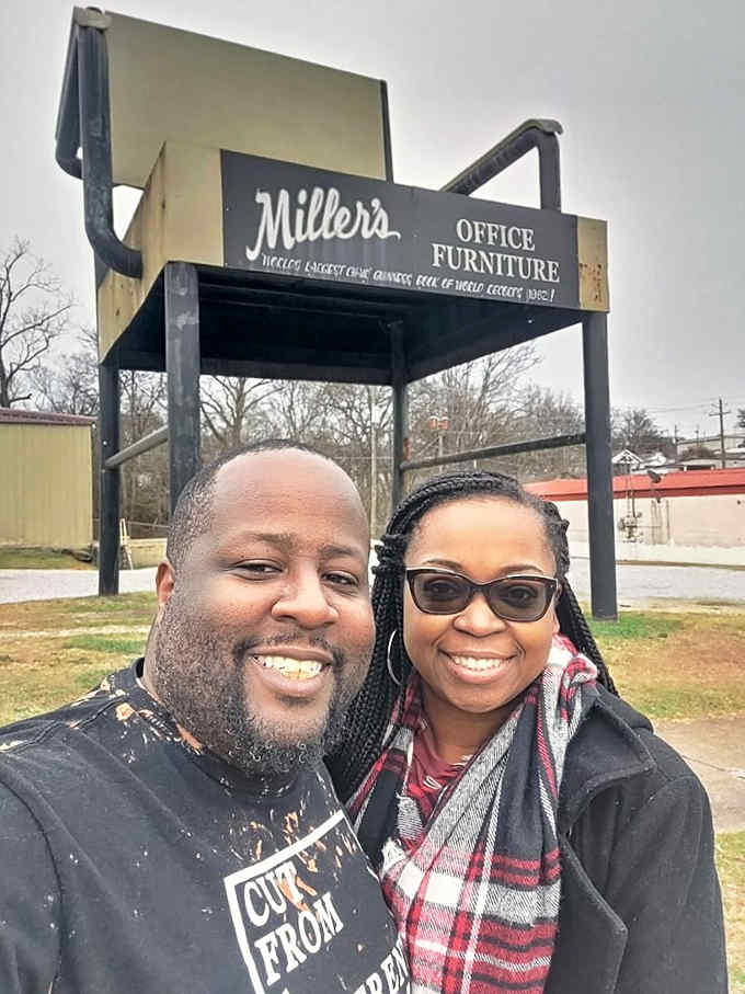 Nothing says "successful road trip" quite like a couples photo with an impossibly large piece of office furniture, honestly.