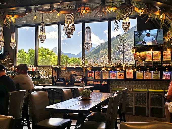 The bar area where mountain views compete with crystal chandeliers for your attention. This is what happens when rustic charm meets unexpected elegance.