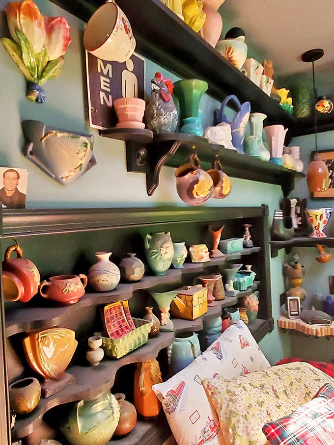 This collection of vintage pottery transforms ordinary shelves into a museum-worthy display of American ceramic art.