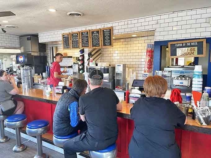 The counter view&mdash;where ice cream dreams come true and diet plans go to die. That "Flavor of the Week" sign is basically a local landmark.