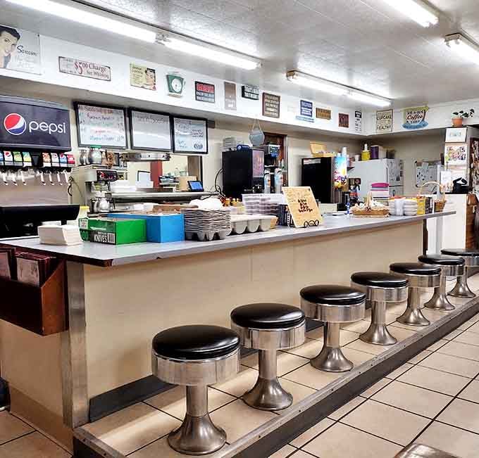 Counter seating: where solo diners become temporary members of the Sandy's family and the coffee refills flow like mountain streams.