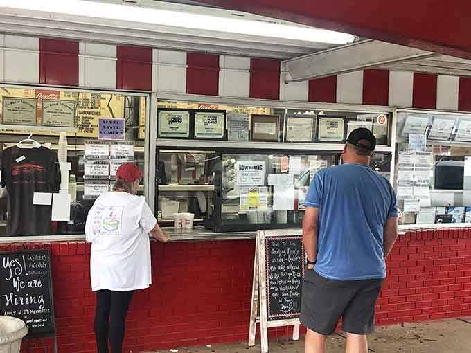 The sacred ritual of ordering at the window. Regulars know exactly what they want; first-timers are about to have their lives changed forever.
