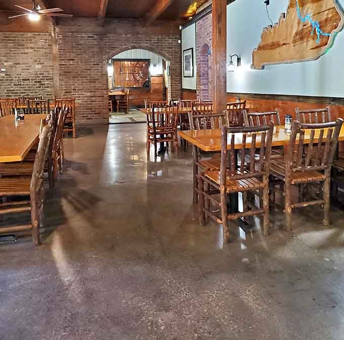 Exposed brick and polished floors blend industrial cool with riverside warmth in this spacious dining room beautifully.