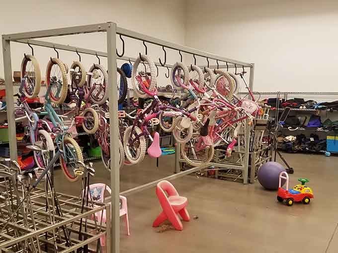 Kid's bikes hanging like art installations, waiting to teach the next generation that wheels and deals go perfectly together.