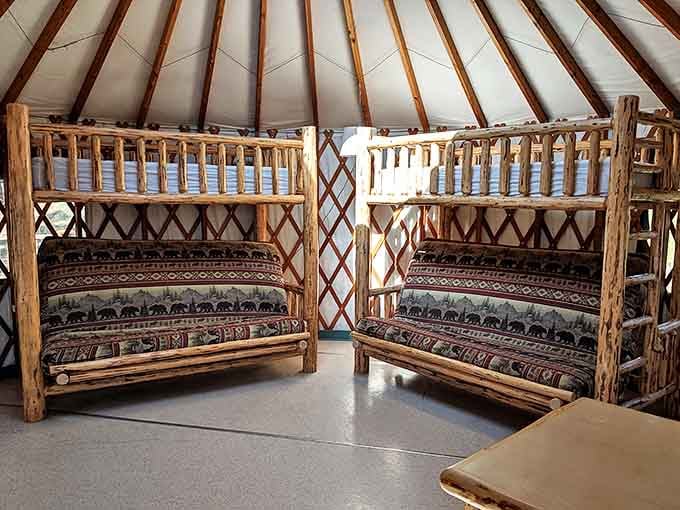 Inside these yurts, rustic meets comfort with handcrafted log furniture. The bear-themed blankets aren't subtle, but they're perfectly Montana.