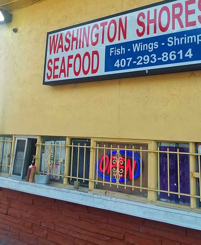 That "OPEN" sign might as well say "PARADISE" &ndash; the golden gates to fried fish heaven, where crispy perfection awaits behind those humble security bars.