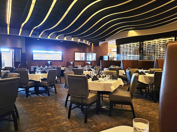 Empty tables waiting for the evening's stories to unfold. Each white tablecloth a blank canvas for memorable meals and conversations.