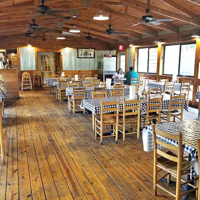 A dining room designed for serious eating. High ceilings, wooden floors, and checkered tablecloths set the stage for the main event: the food.