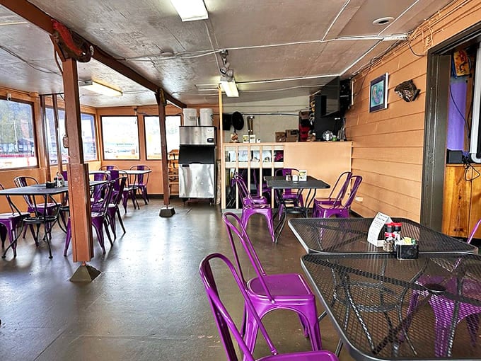 Purple chairs pop against wooden walls in a dining room that feels like the living room of your coolest Alaskan friend.