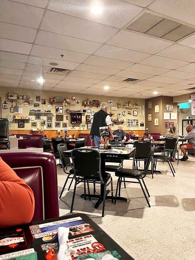 Classic diner seating and walls adorned with memorabilia&mdash;not the curated kind, but the authentic collection that accumulates over years of community.