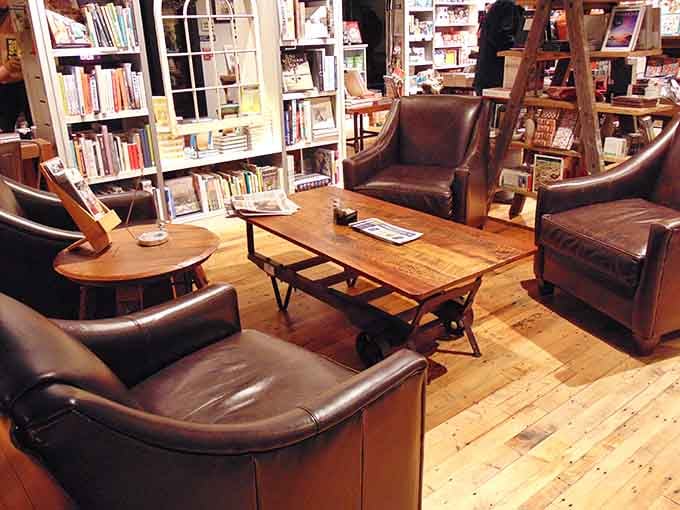 Leather chairs that whisper "stay awhile" while you sample your next potential literary obsession comfortably.