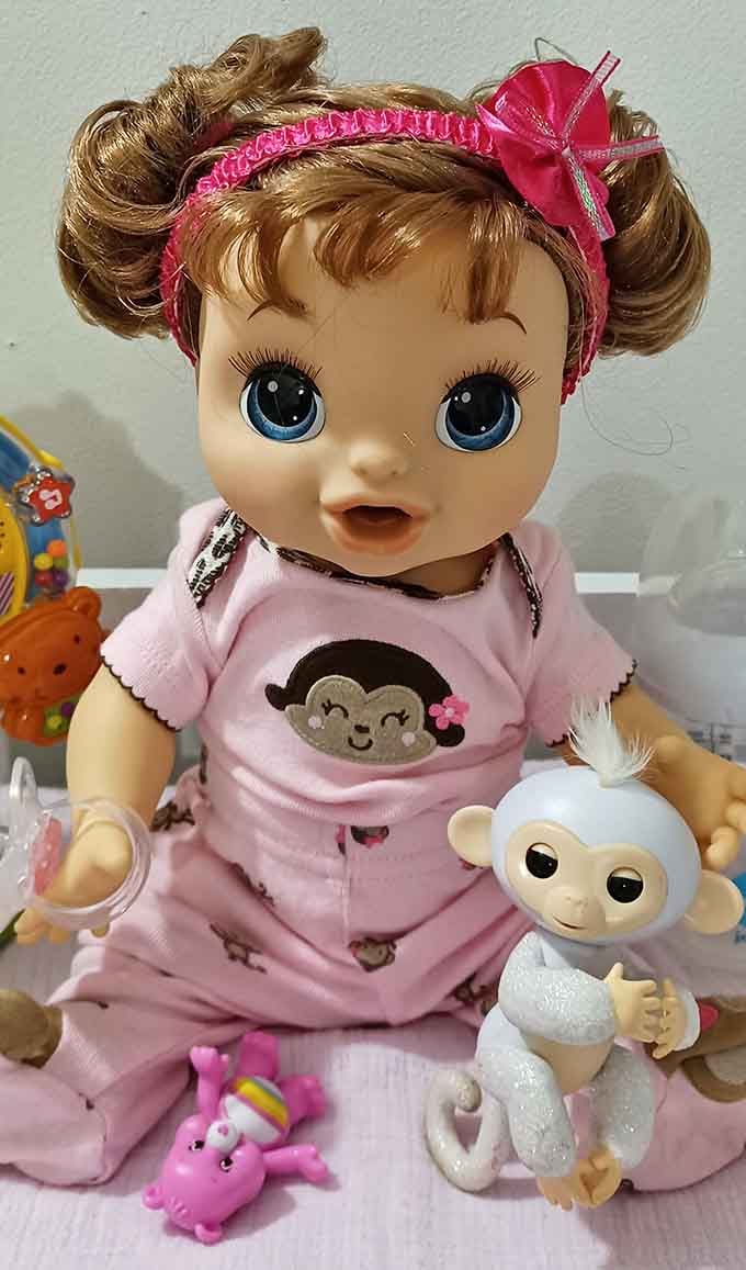 This wide-eyed doll and her monkey friend have seen things. Now they're ready for new adventures in someone's playroom.