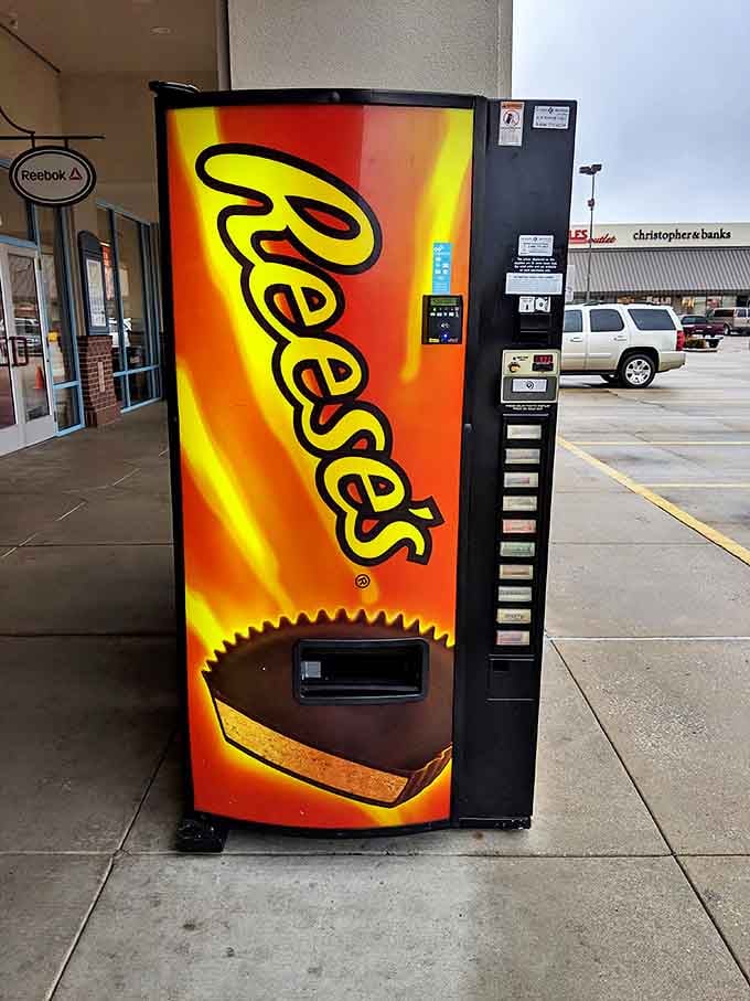 The Reese's vending machine stands as a beacon of hope for desperate shoppers. When hunger strikes mid-bargain hunt, peanut butter cups become retail fuel.