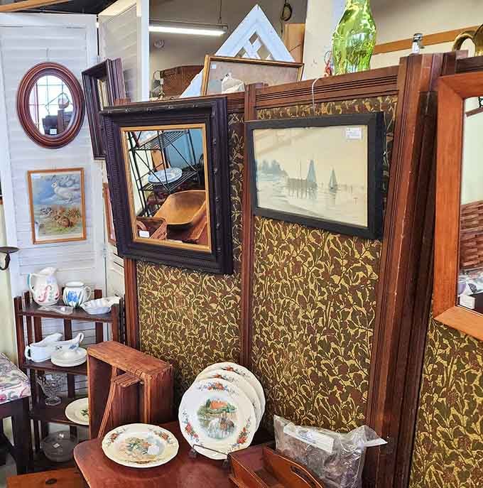 Decorative screens and framed artwork create vignettes of bygone elegance. That sailboat print probably hung in a sea captain's study a century ago.