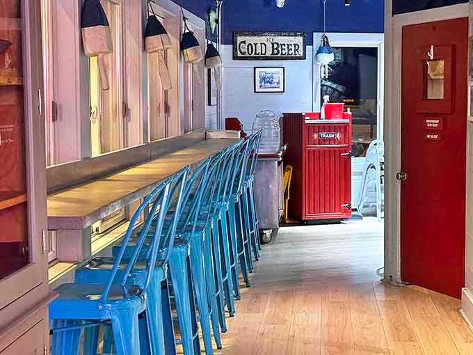 Blue counter seating with a "Cold Beer" promise above&mdash;sometimes the simplest pleasures are the most satisfying, especially after a lobster roll.