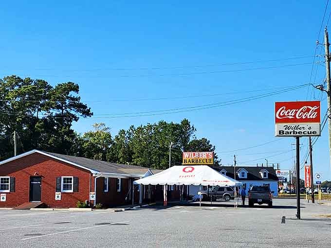 The brick building and classic Coca-Cola sign create an old-school barbecue atmosphere that feels like coming home again.