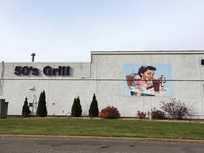 The exterior mural features a cheerful server who's been smiling at Brooklyn Center traffic for years without complaint.