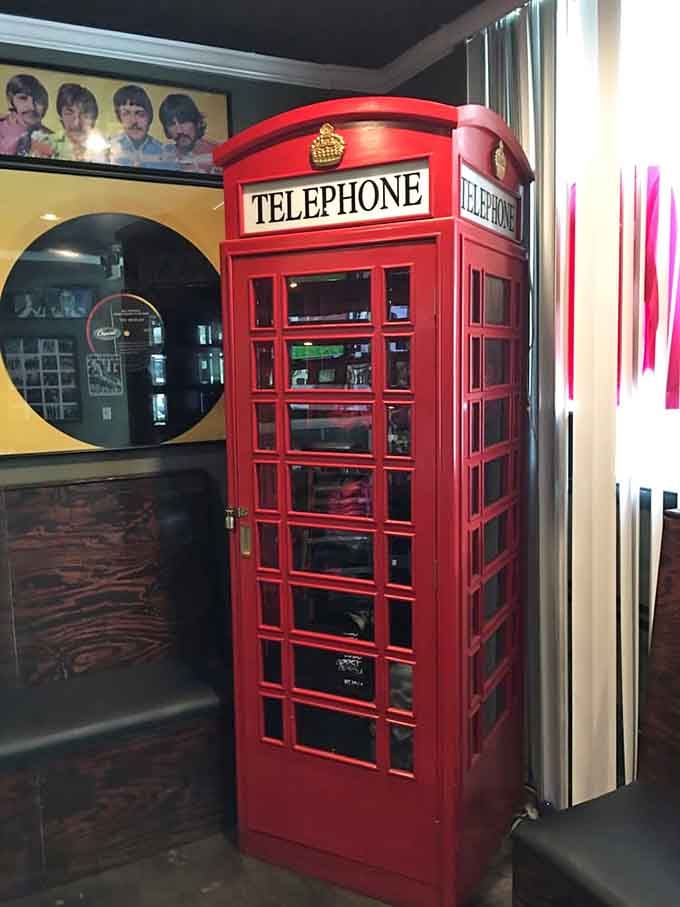 A bright red British telephone booth stands ready for your best tourist photo op moment.