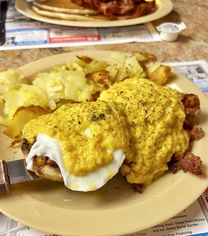 Eggs Benedict drowning in hollandaise sauce, because sometimes breakfast needs to wear its Sunday best and taste heavenly.