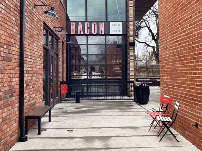 The entrance beckons with red chairs and brick walls, promising bacon adventures that'll make your Instagram followers weep.