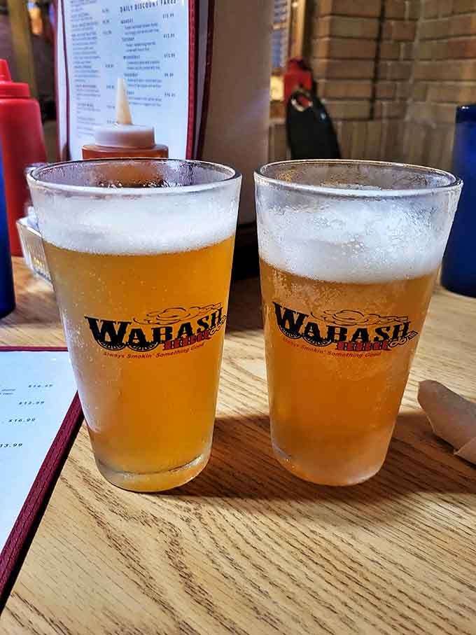 Cold beer in branded glasses&mdash;because proper barbecue deserves proper hydration. These golden pints are the perfect palate cleansers between bites of smoky heaven.