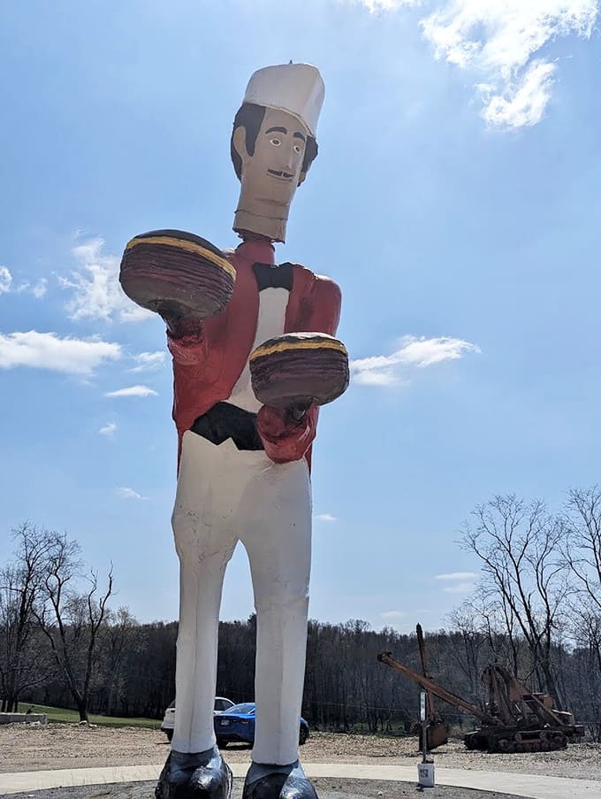 The towering chef statue outside holds burgers aloft like edible trophies welcoming hungry travelers to paradise.