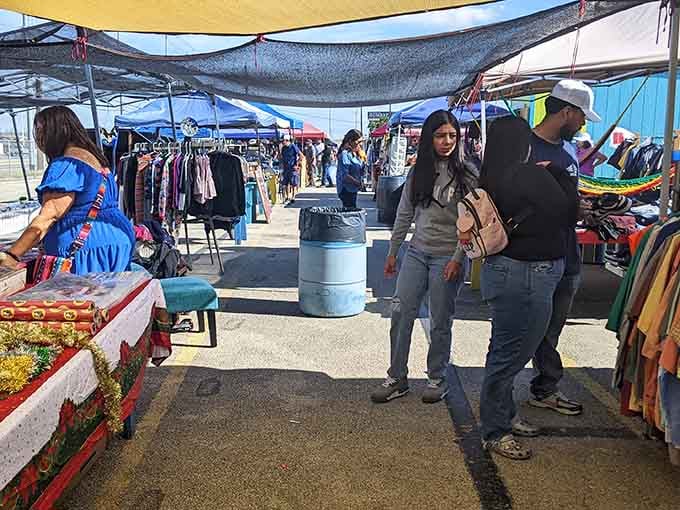 Shade canopies stretch across the outdoor market creating a shopping corridor where deals flow as freely as conversation.