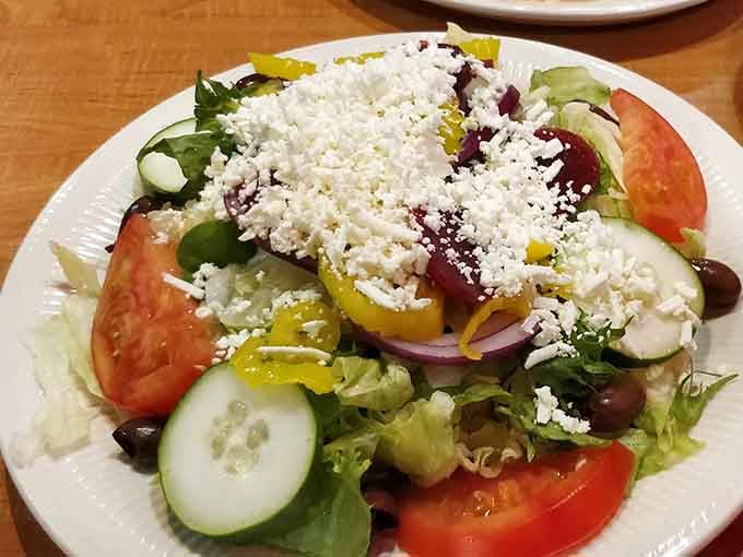 A Greek salad so generously topped with feta it looks like it snowed cheese, making vegetables feel like an actual celebration.