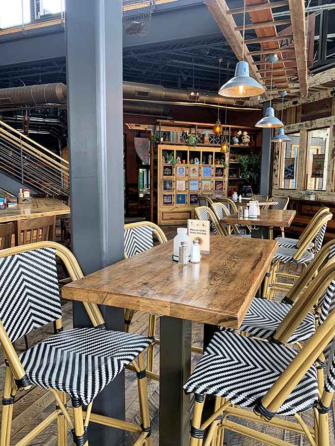 Rustic charm meets Parisian bistro vibes&mdash;where weathered wood tables and chevron-striped chairs invite lingering conversations over good food.