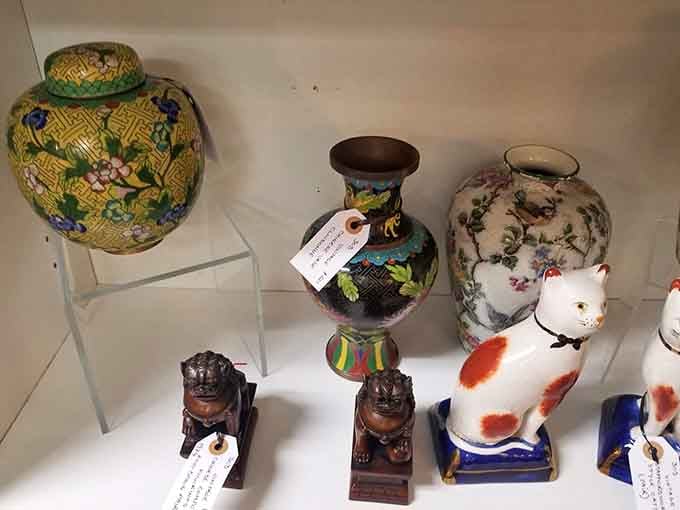 Cloisonn&eacute; vases and porcelain cats proving that decorative taste is wonderfully subjective across the decades.
