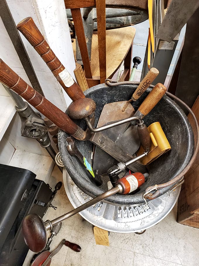 Hand tools with wooden handles worn smooth by decades of use, back when things were built to last.