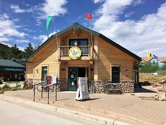 The wooden building housing this carousel looks like it belongs in a storybook about mountain magic and childhood dreams.
