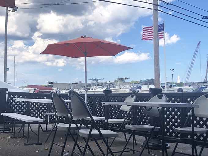 Outdoor seating with harbor views lets you watch fishing boats while contemplating your upcoming seafood adventure ahead.