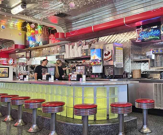 Counter seating with chrome stools where strangers become friends over coffee and hash browns every morning.