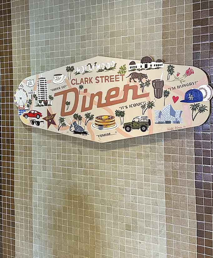 This playful wall sign captures everything iconic about Los Angeles, from Dodgers caps to palm trees.