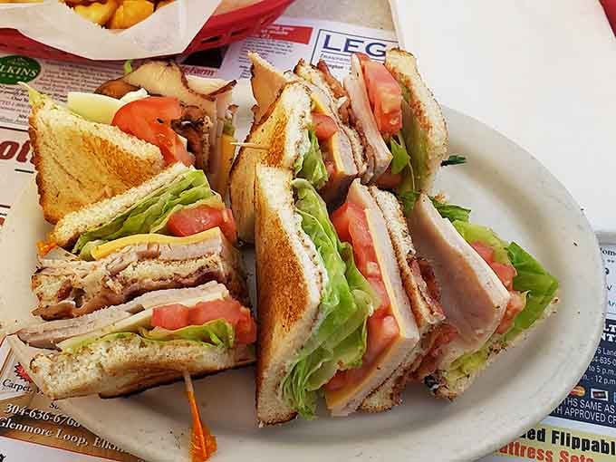 The club sandwich: architectural marvel of the diner world, where each layer contributes to a skyscraper of flavor that's worth the jaw stretch.
