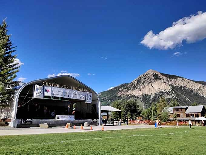 The outdoor stage at Town Park hosts performances under skies so blue they make you question your screen settings.