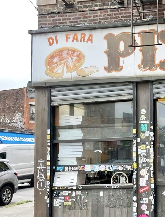 The faded signage outside whispers promises of pizza perfection that the place absolutely delivers on every single time.
