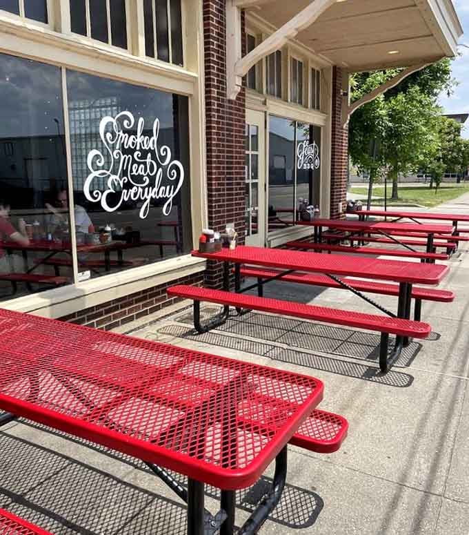 Red picnic tables outside for when the weather cooperates and you want your barbecue with a side of sunshine.