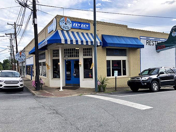 Fly Boy Pizza's blue-and-white awning signals a local favorite where the pies likely come with generous toppings and zero pretension.